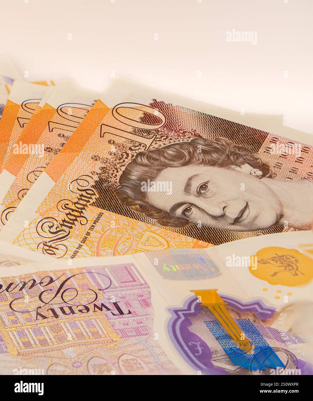 a few hundred pound of new GBP £ Sterling Ten 10 pound notes in a small ...