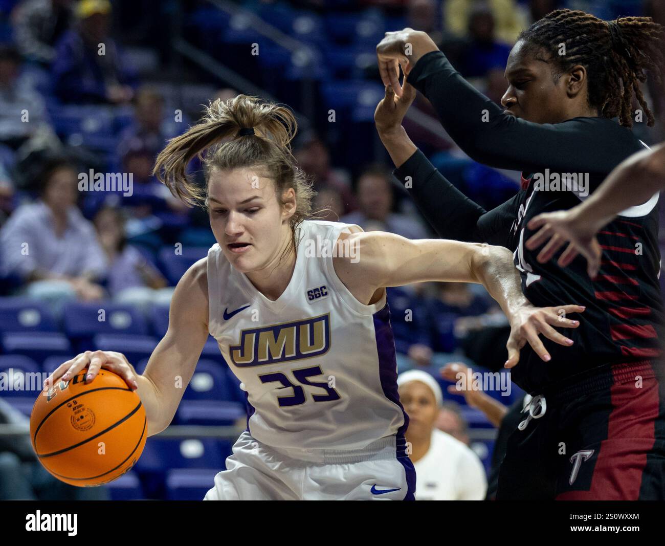 James Madison center Kseniia Kozlova (35) drives around Troy center ...