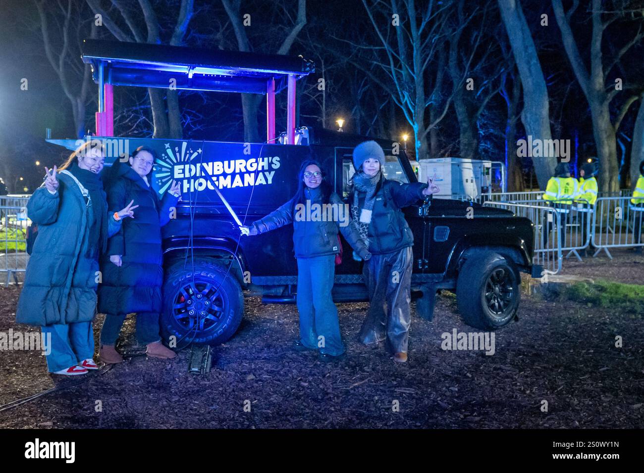 Attendees pose in front of a DJ van after this years event was ...