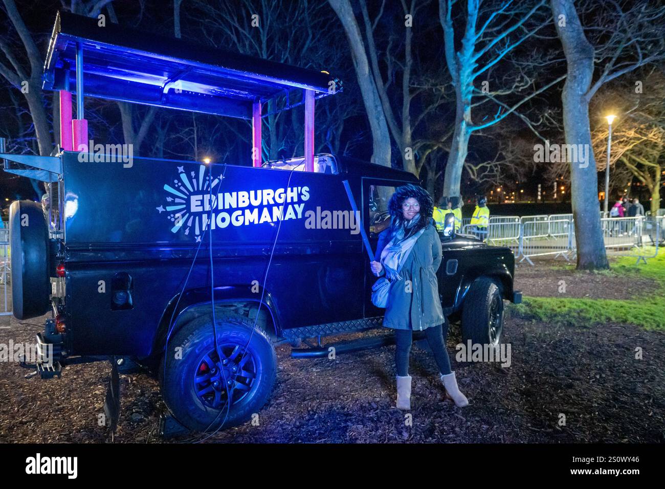 Attendees pose in front of a DJ van after this years event was ...