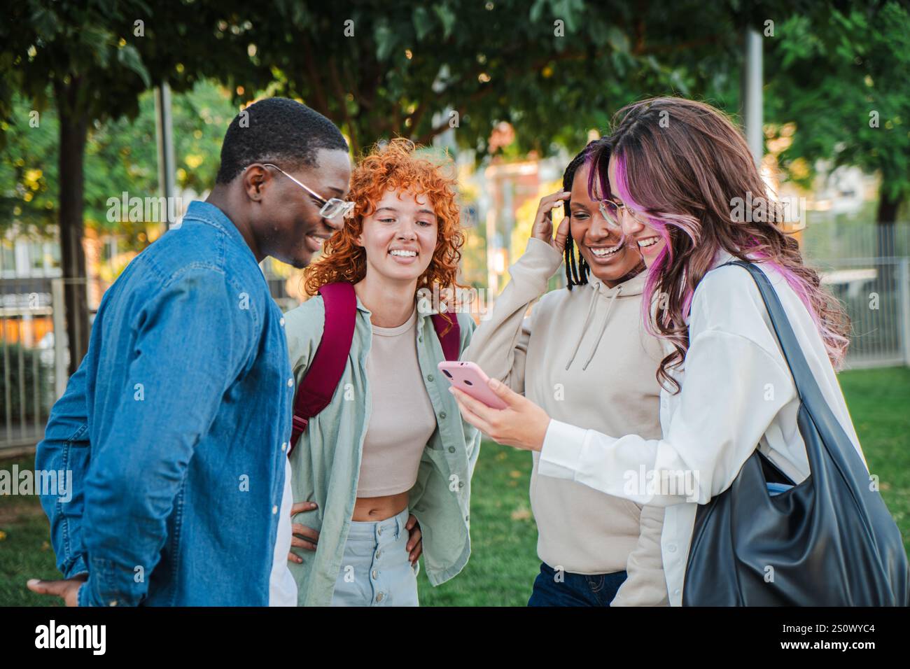 Group of multiracial teenage students talking and laughing outdoors ...