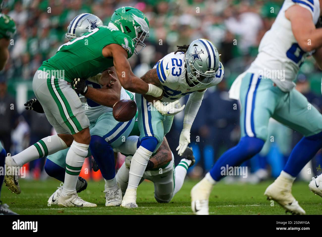 Philadelphia Eagles linebacker Nolan Smith Jr., left, punches the ball ...