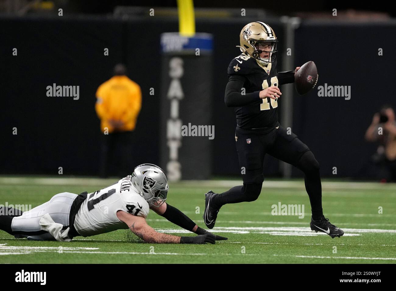 New Orleans Saints quarterback Spencer Rattler (18) runs from Las Vegas Raiders linebacker ...