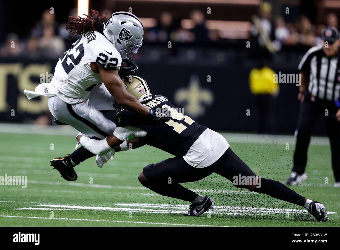 Las Vegas Raiders running back Alexander Mattison (22) is tackled by ...