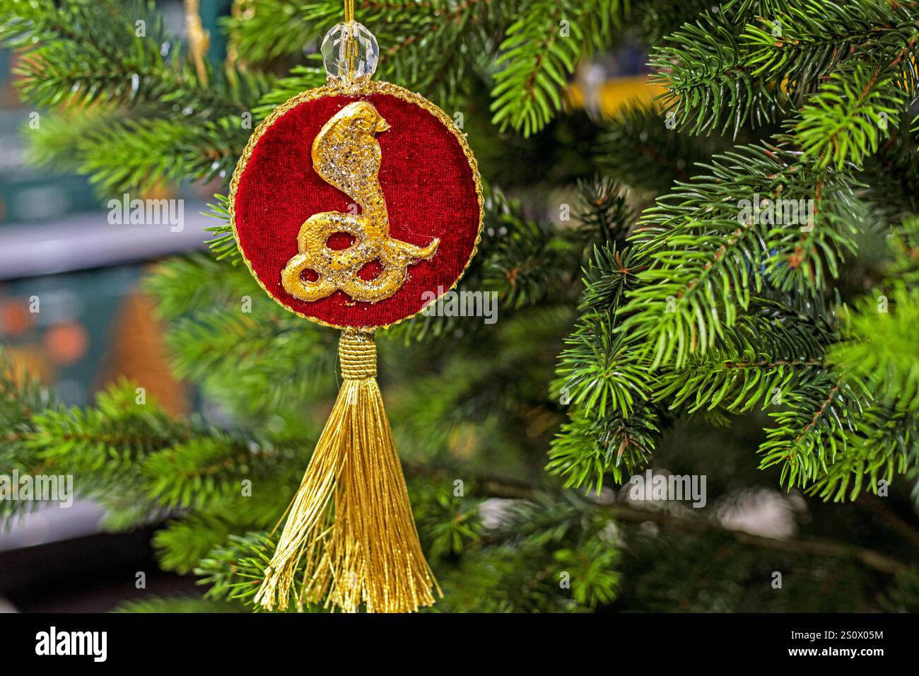 embroidered decoration snake symbol on red background on Christmas tree ...