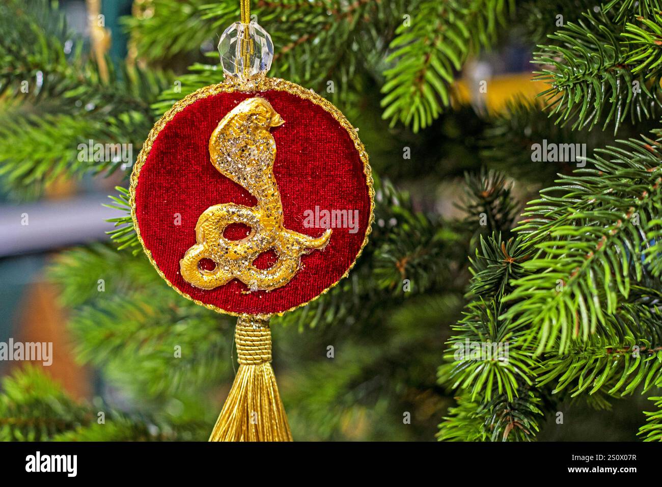 embroidered decoration snake symbol on red background on Christmas tree ...