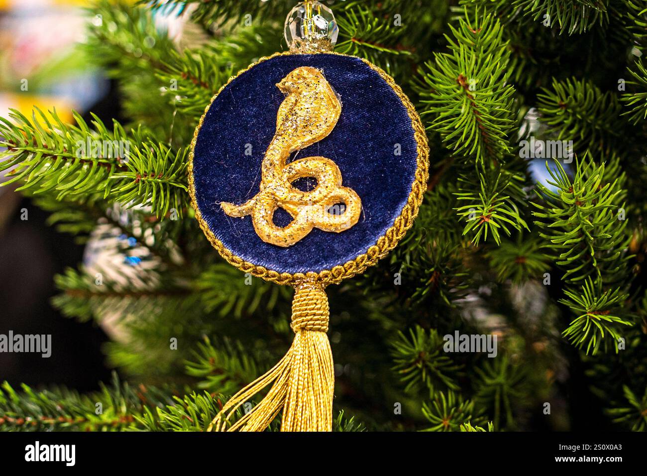decoration snake symbol on green background on Christmas tree. Chinese ...