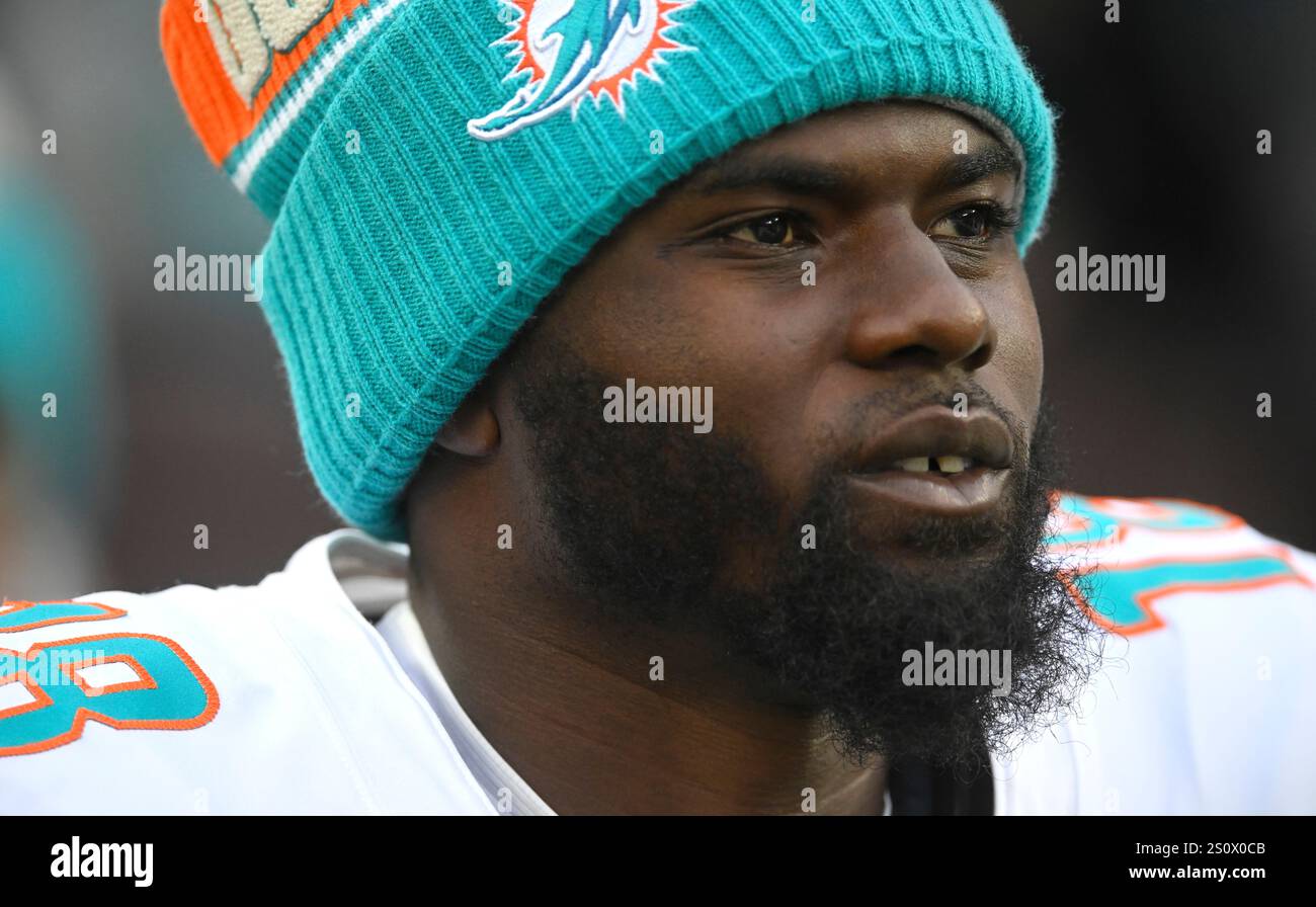 Miami Dolphins quarterback Tyler Huntley stands on the field before an ...