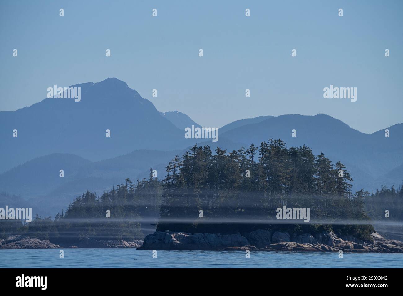Foglines in front of an little island in the Broughton Archipelago with ...