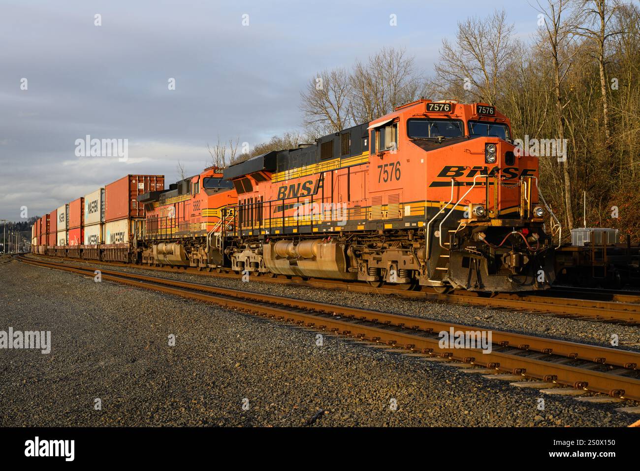 Seattle, WA, USA - December 16, 2024; BNSF intermodal container freight train with multiple ...