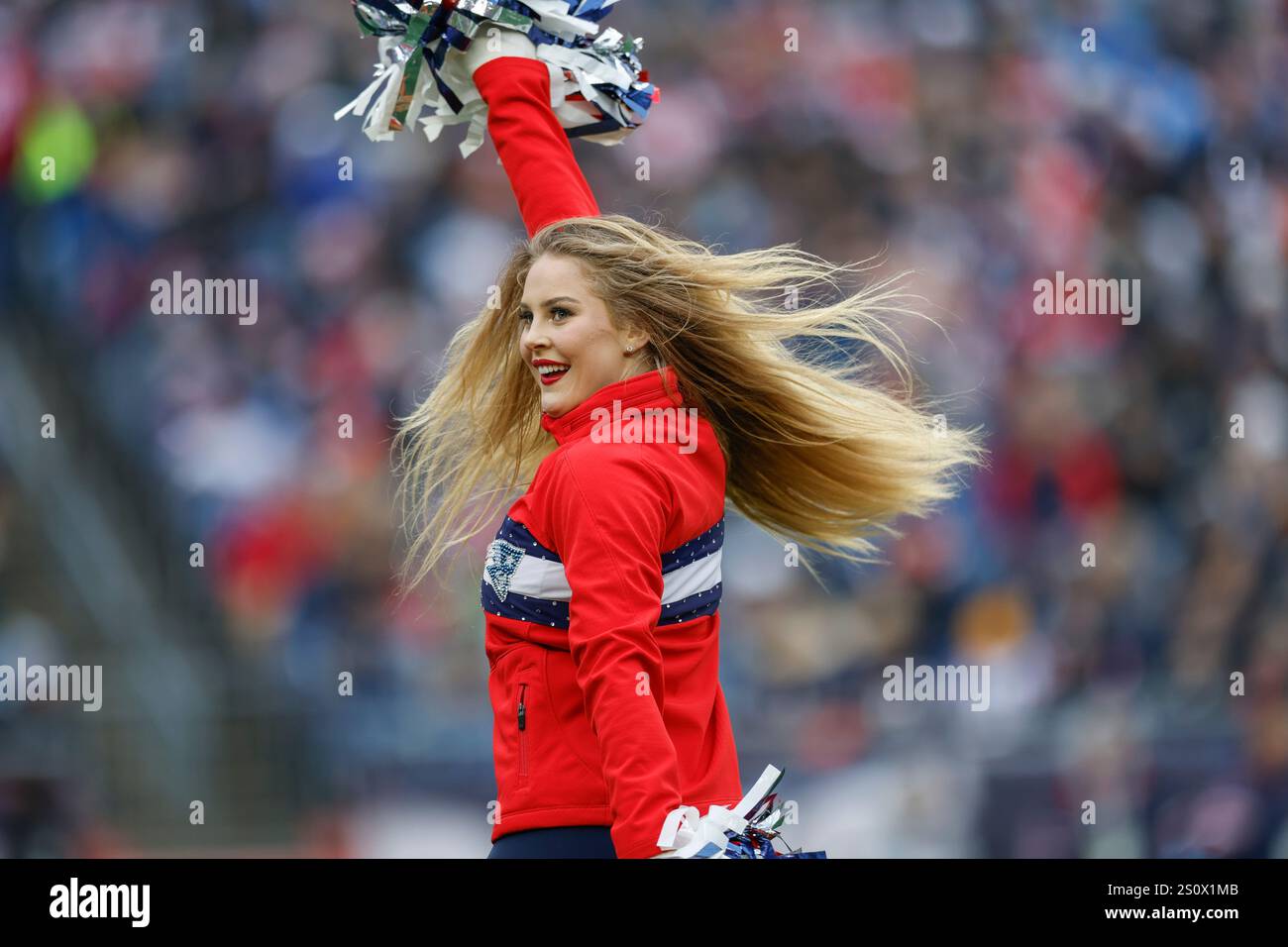 A New England Patriots cheerleader performs during the first half an ...
