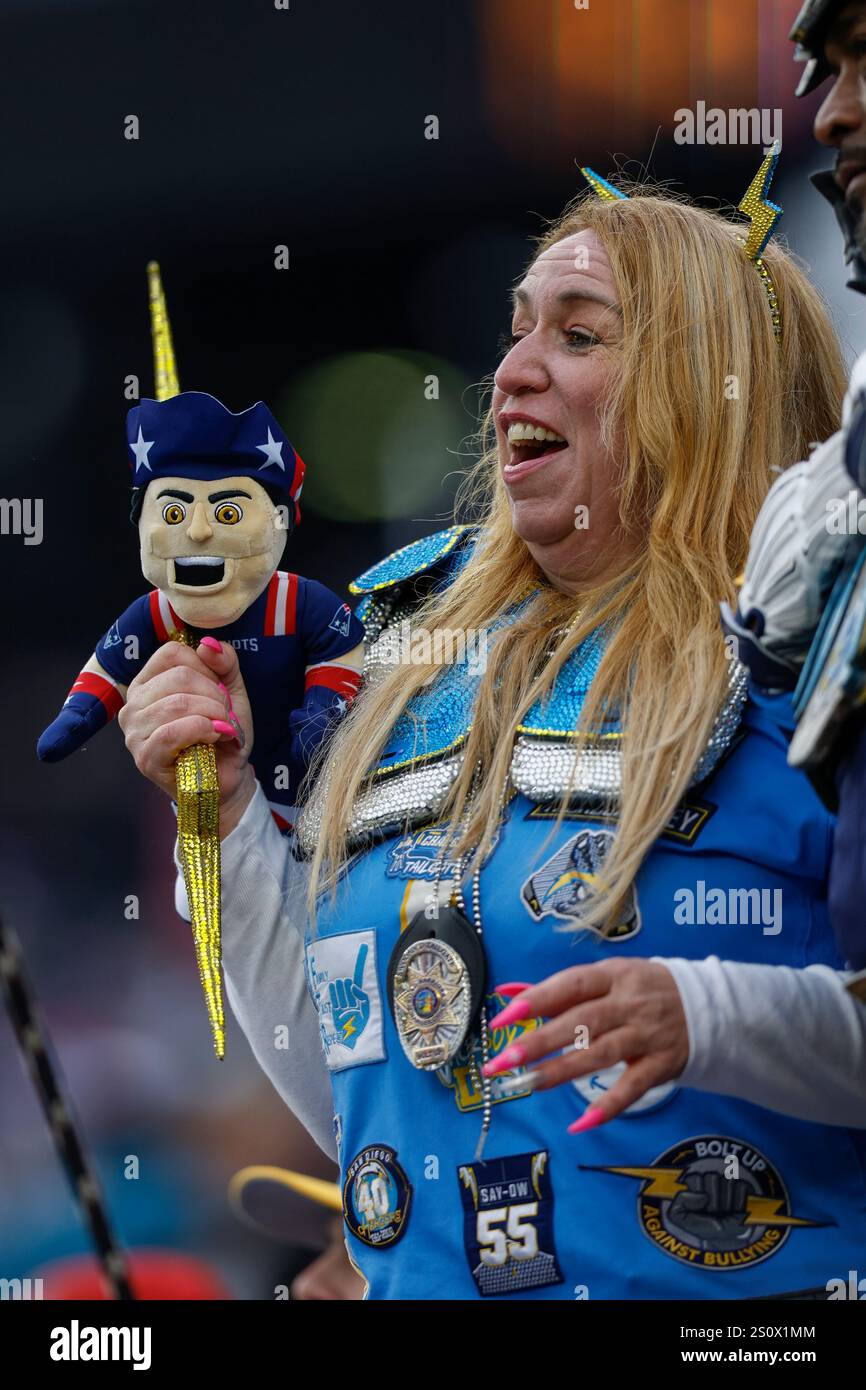 A Los Angeles Chargers fan holds a New England Patriots mascot skewered ...