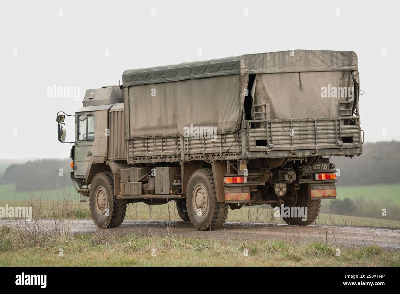 British army MAN SV 4x4 logistics truck, driving an unmade road, in ...
