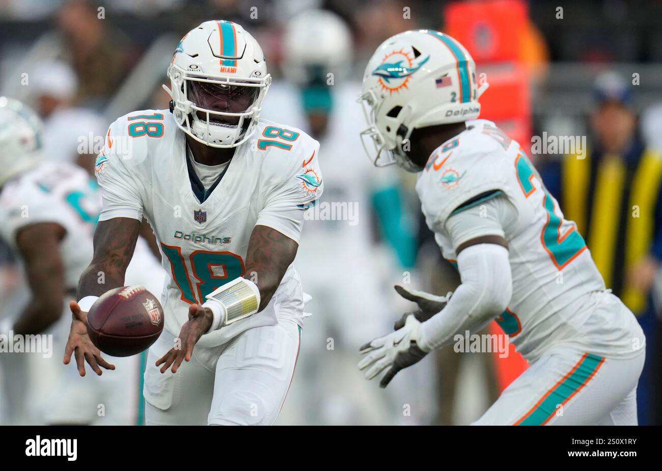 Miami Dolphins quarterback Tyler Huntley (18) tosses the ball to ...