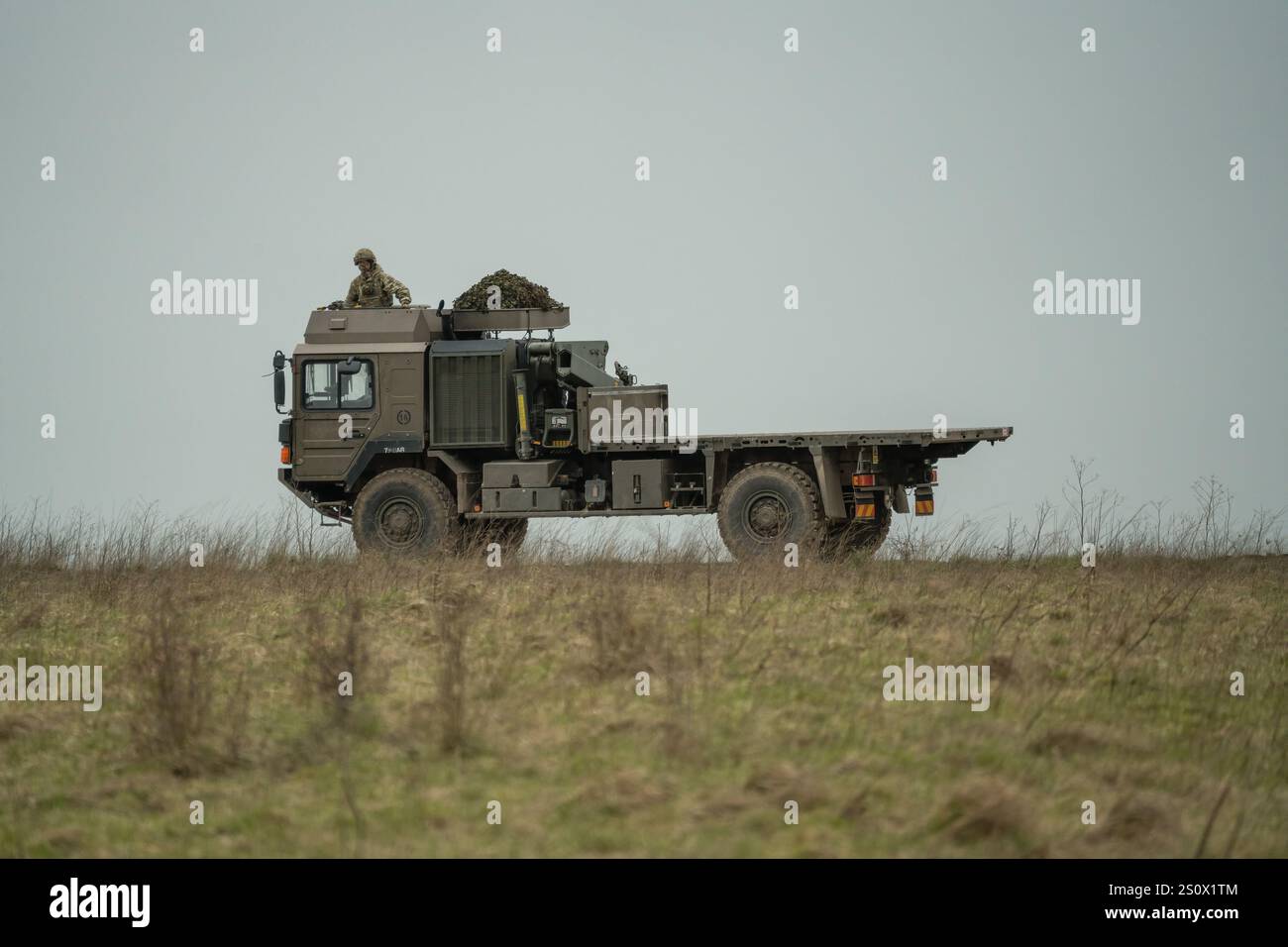 British army MAN SV 4x4 logistics truck, driving an unmade road, in ...