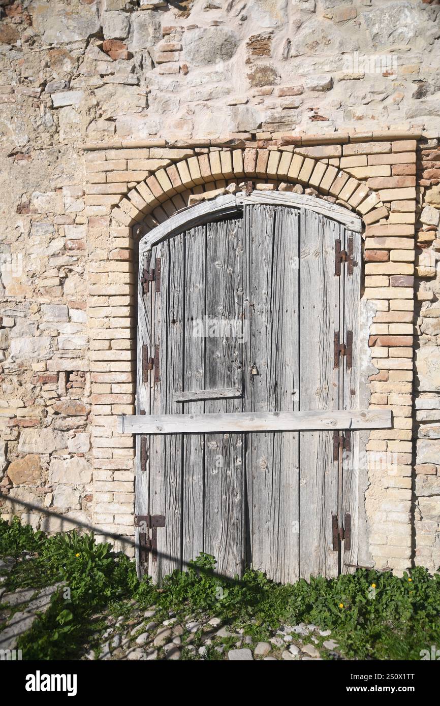 Detail of an old wooden door inside the abandoned city of Craco, a ...