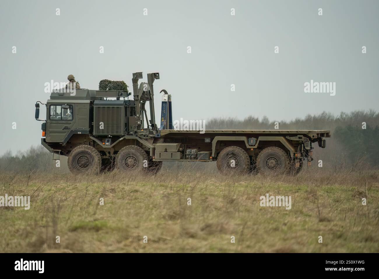 British army MAN SV 8x8 EPLS logistics truck driving an unmade road, in ...