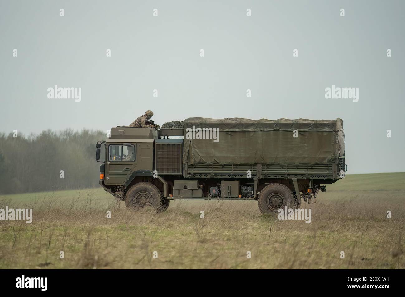 British army MAN SV 4x4 logistics truck, driving an unmade road, in ...