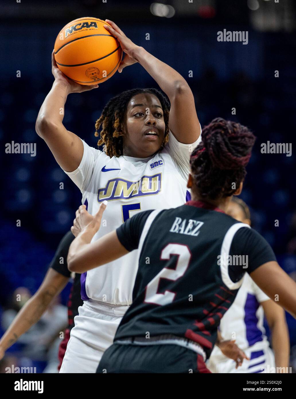 James Madison forward Ashanti Barnes, top left, looks for an opening ...