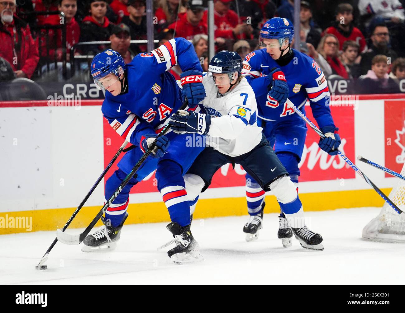 Finland's Daniel Nieminen (7) fights to keep the puck from United ...