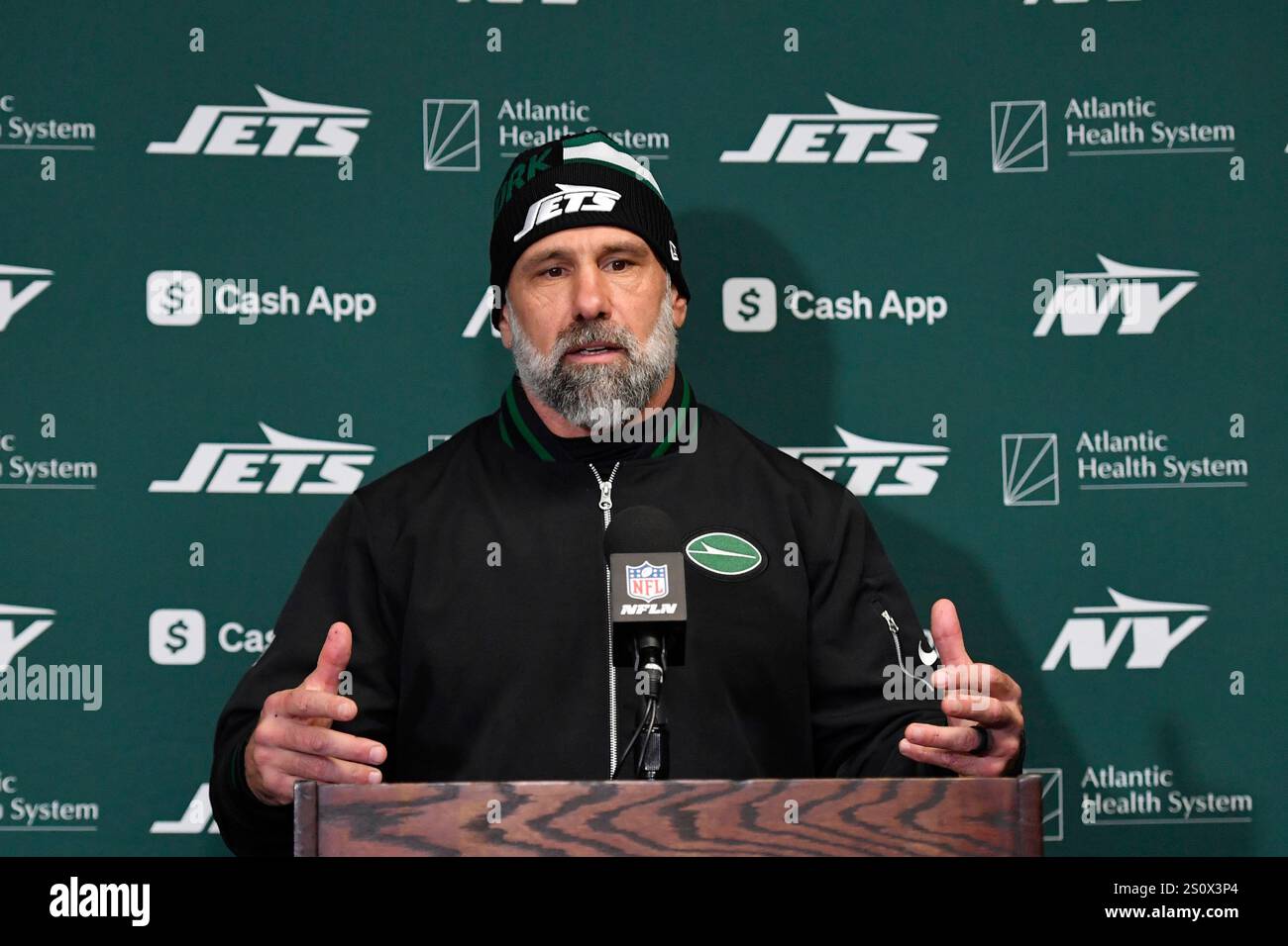 New York Jets head coach Jeff Ulbrich talks to the media following an ...