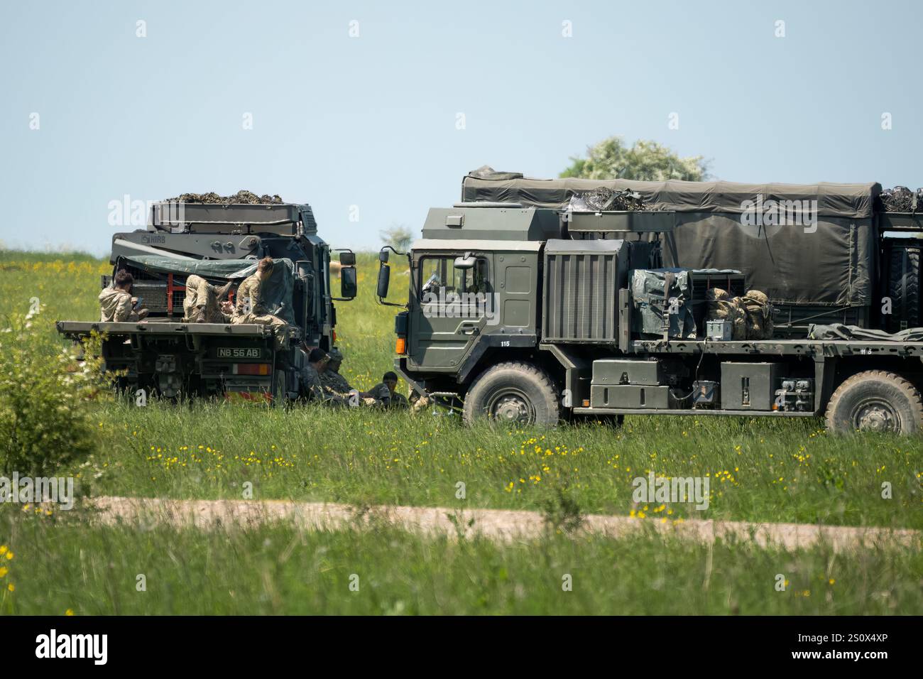 British army MAN SV 4x4 Heavy Utility logistics trucks with a Bulldog ...