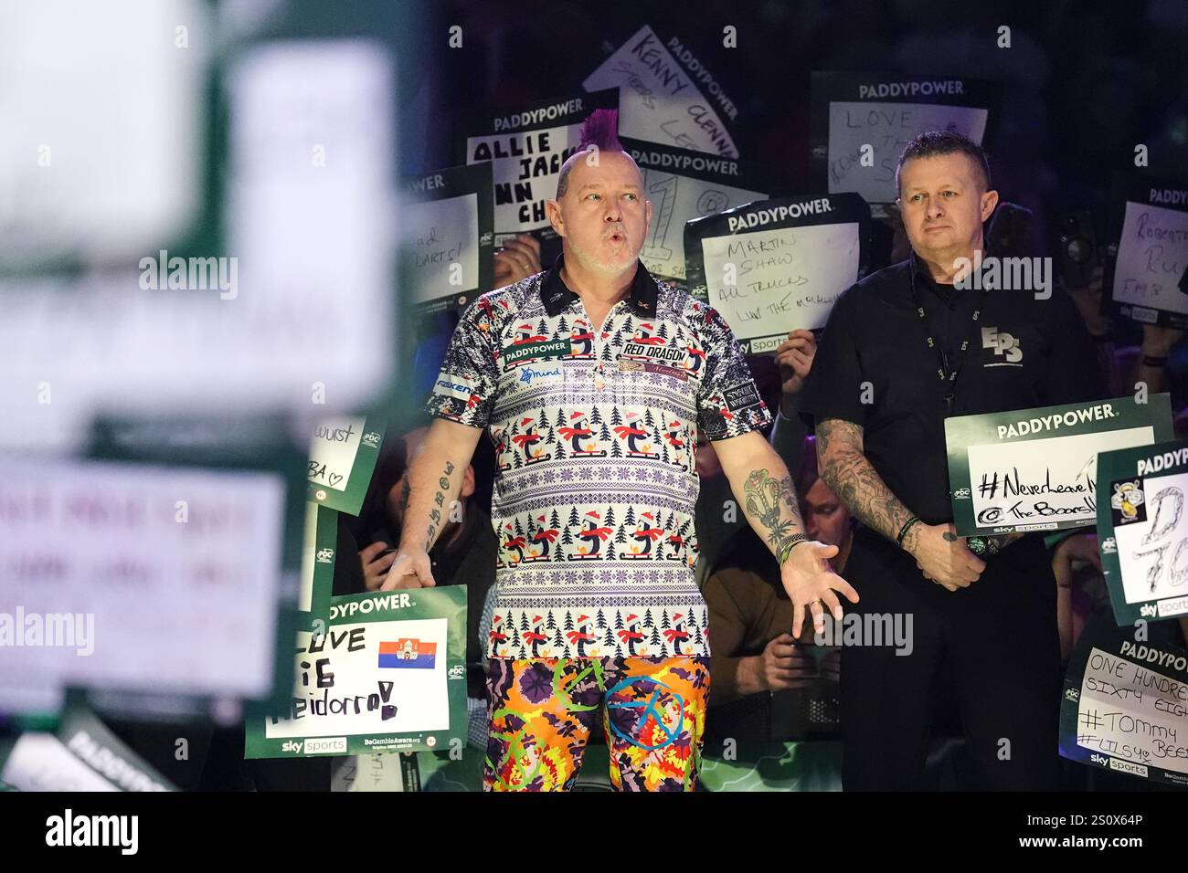 Peter Wright walks out to play Luke Humphries (not pictured) on day ...