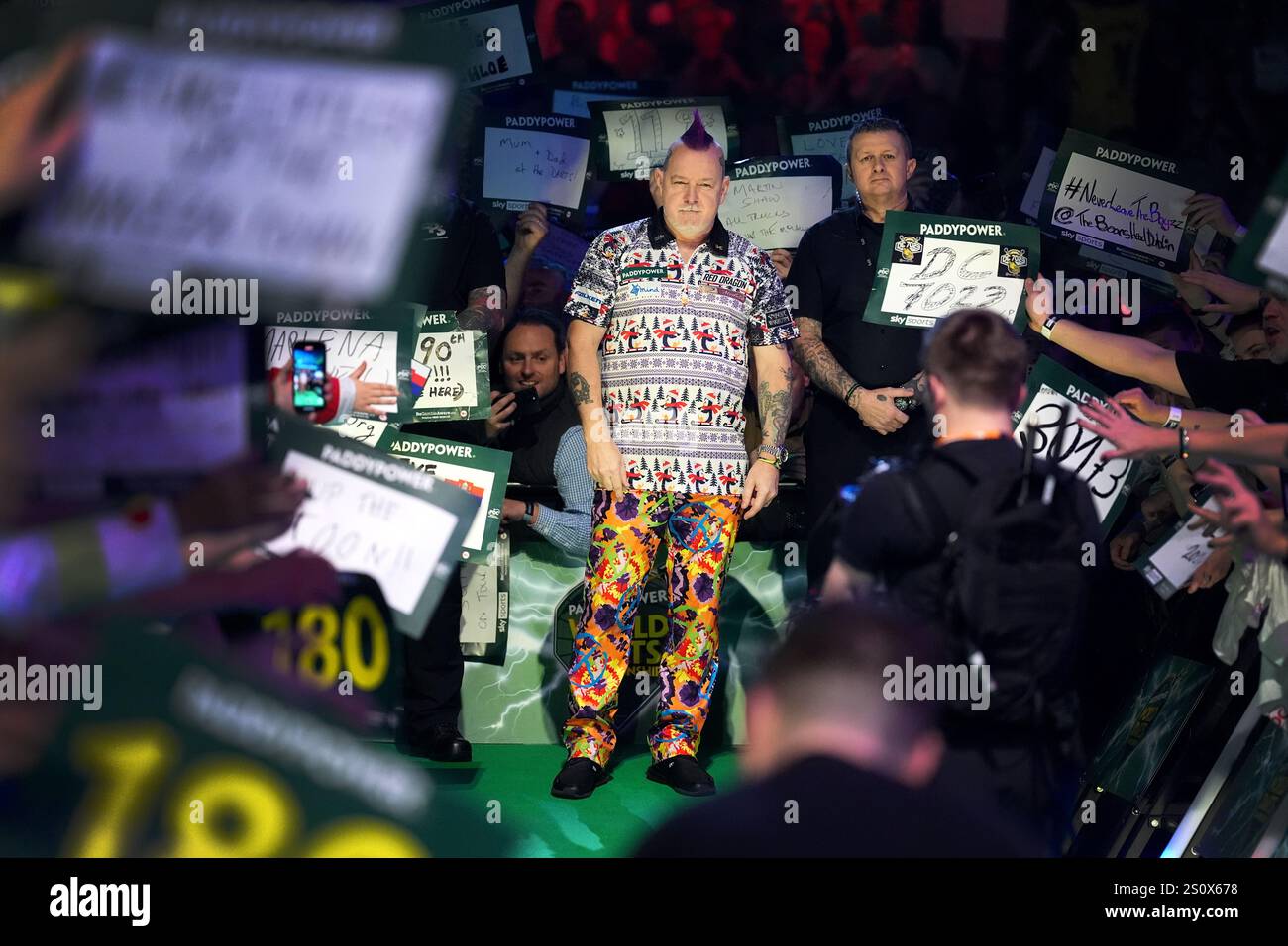 Peter Wright walks out to play Luke Humphries (not pictured) on day ...