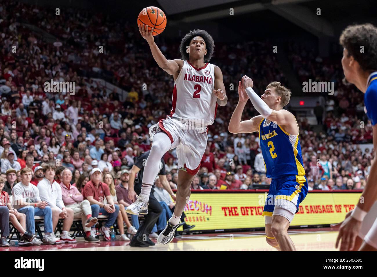 Alabama guard Aden Holloway, center left, looks to shoot past South ...
