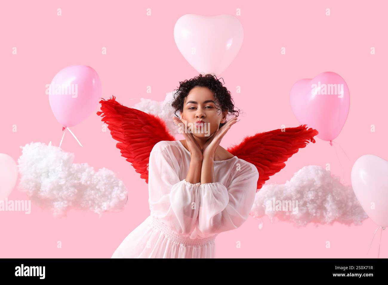 Young African-American woman dressed as Cupid with balloons and clouds ...