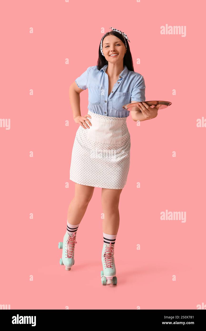 Beautiful young waitress in roller skates with tray on pink background ...