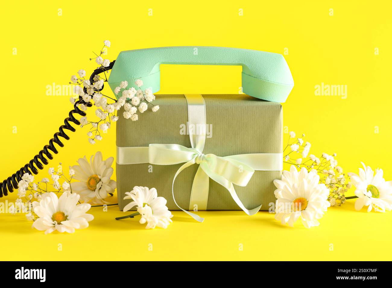 Retro telephone, gift box with beautiful gypsophila and gerbera flowers ...