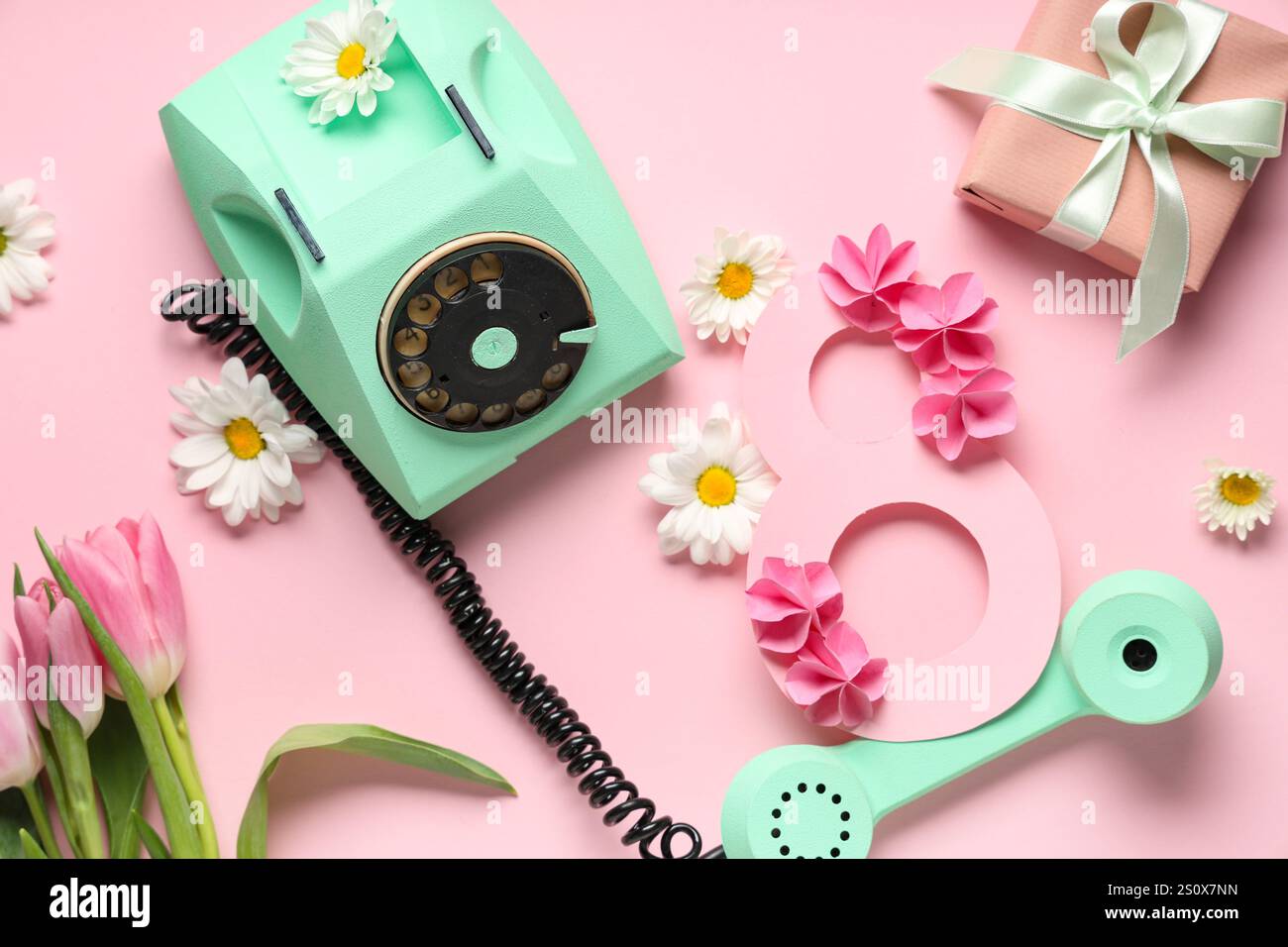 Retro telephone with flowers, gift boxes and figure 8 on pink ...