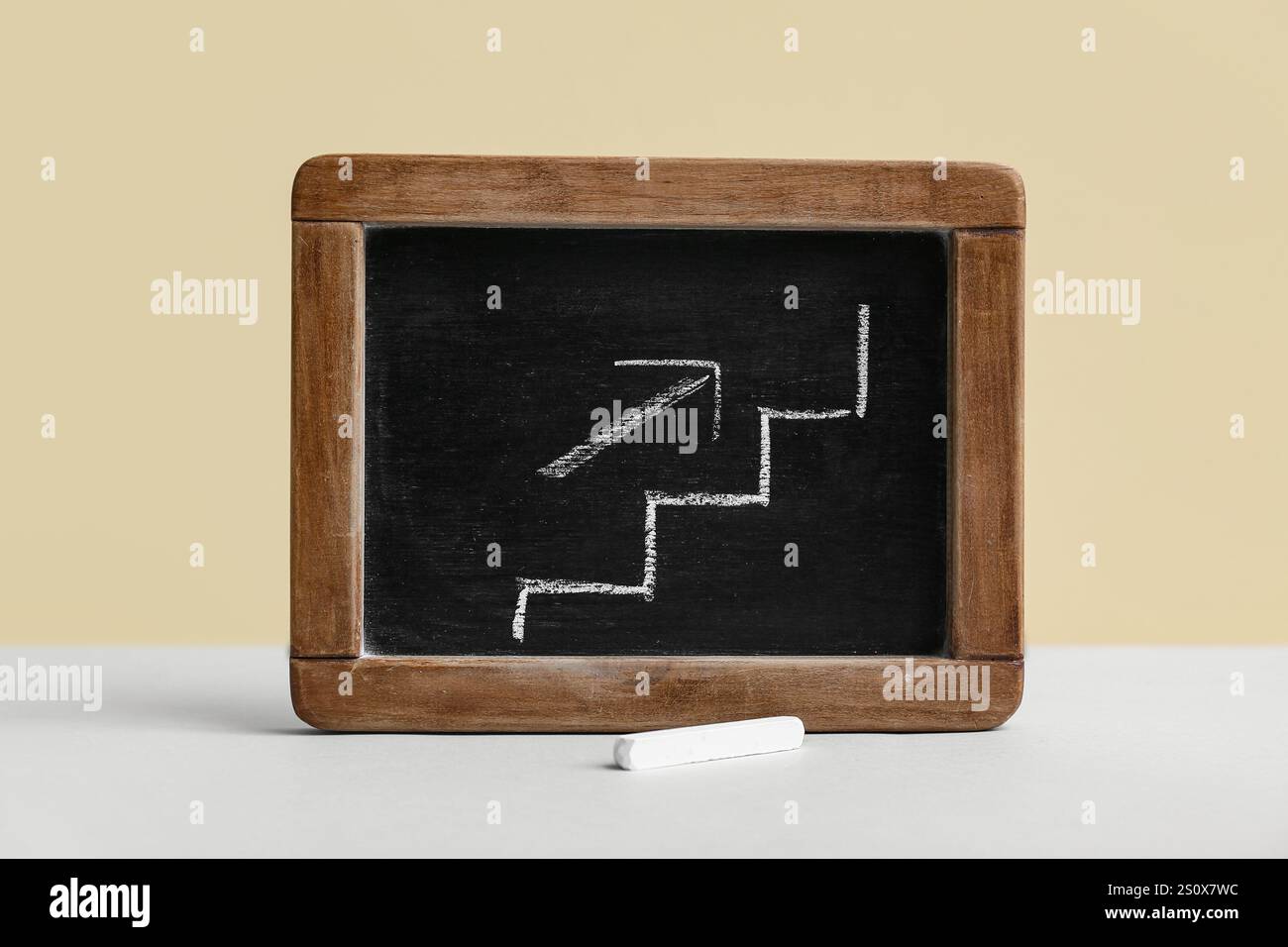 Chalkboard with drawn ladder and arrow on beige background Stock Photo ...