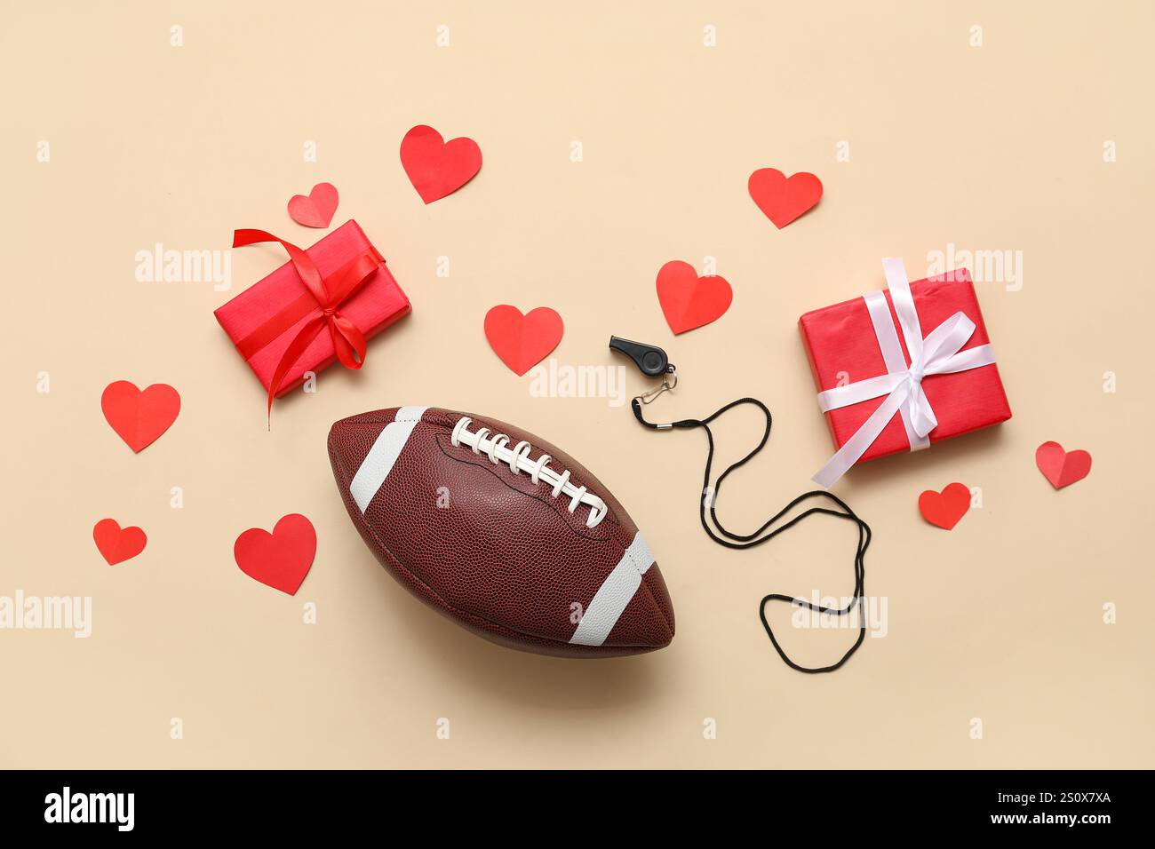 Composition with rugby ball, sports whistle, gifts and red hearts on ...