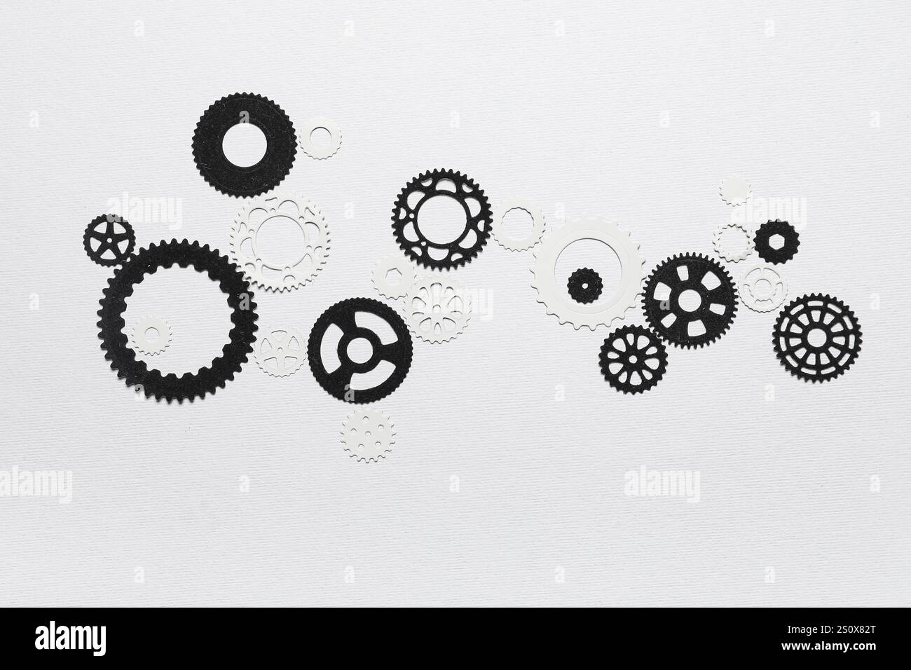 Different paper gears on grey background Stock Photo - Alamy