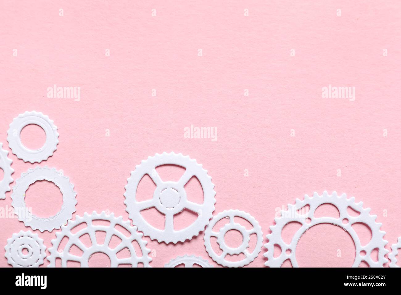 White paper gears on pink background Stock Photo - Alamy