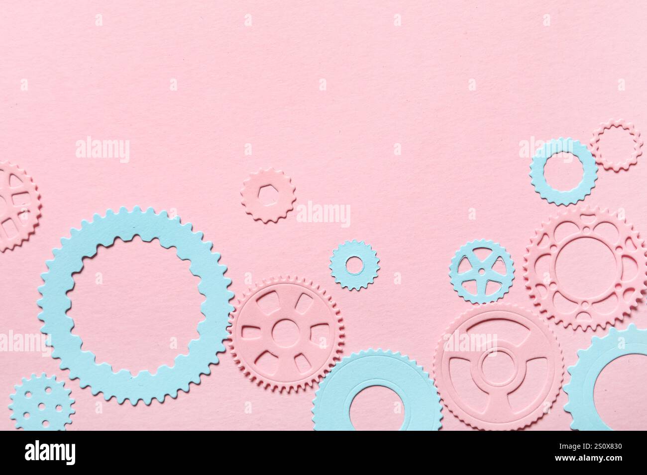 Different paper gears on pink background Stock Photo - Alamy