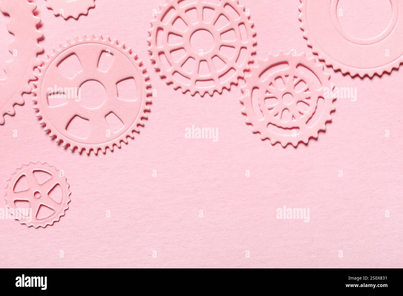 Pink paper gears on color background Stock Photo - Alamy