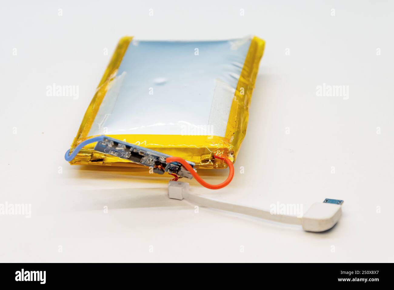 Portable ruined and bloated battery on white background Stock Photo - Alamy