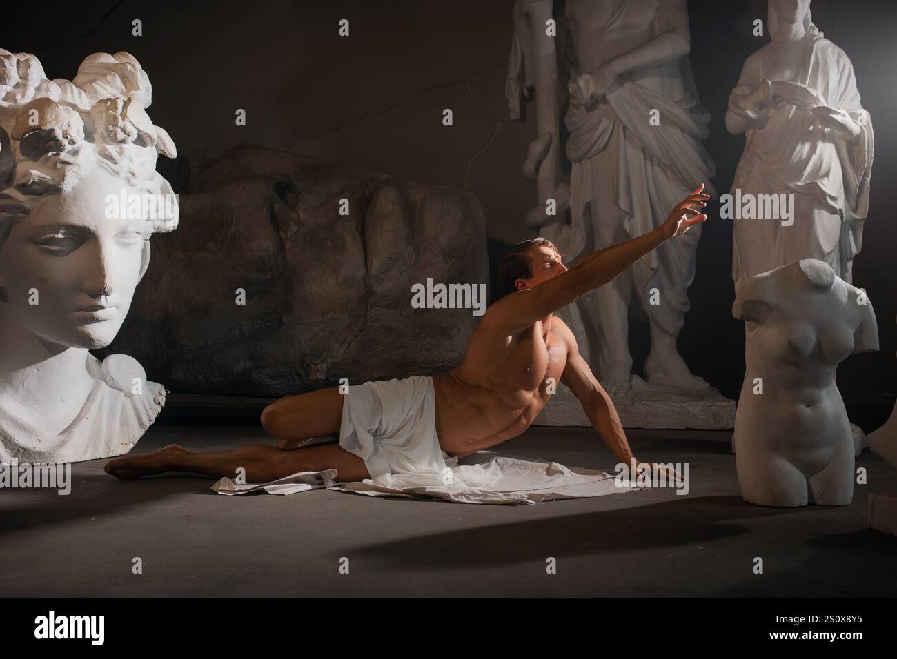 To appeal to the gods. A muscular man in a tunic stretches his hand to ...