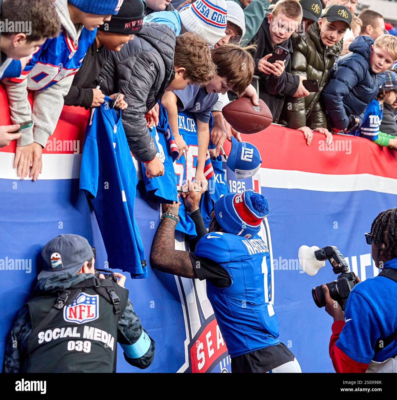 New York Giants wide receiver Malik Nabers (1) sign autographs for fans ...
