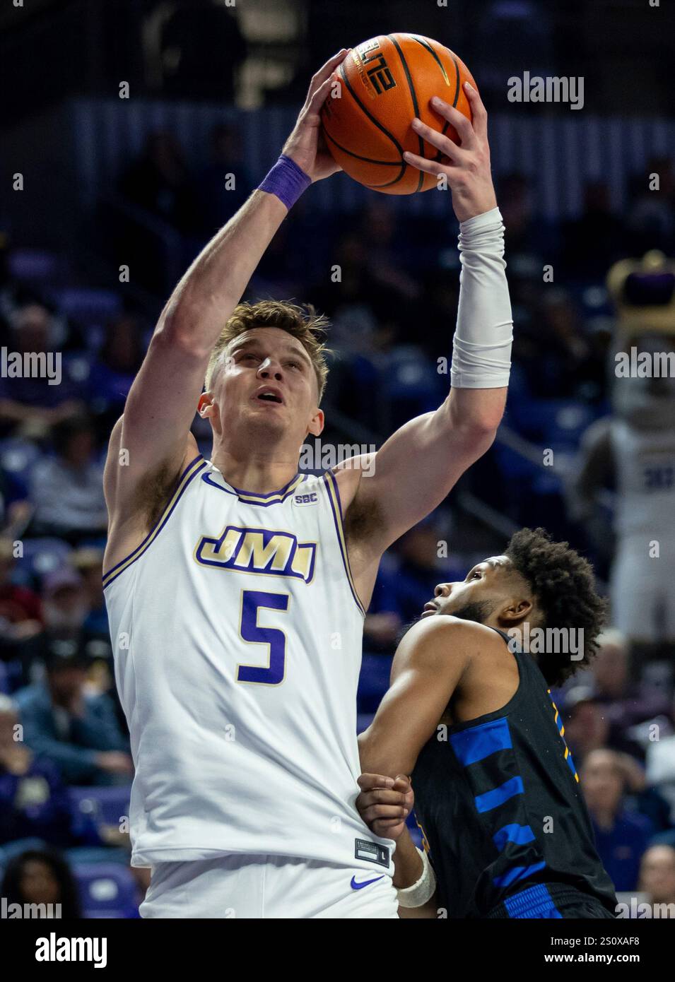 James Madison guard Justin Taylor (5) takes a shot against Midway guard ...