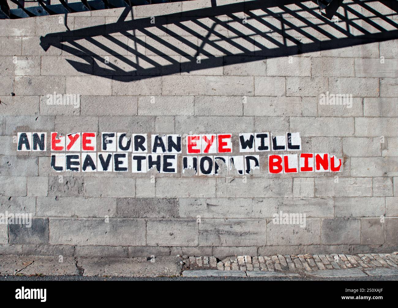 Posters adorn the stone wall of a building in Old Montreal Stock Photo ...