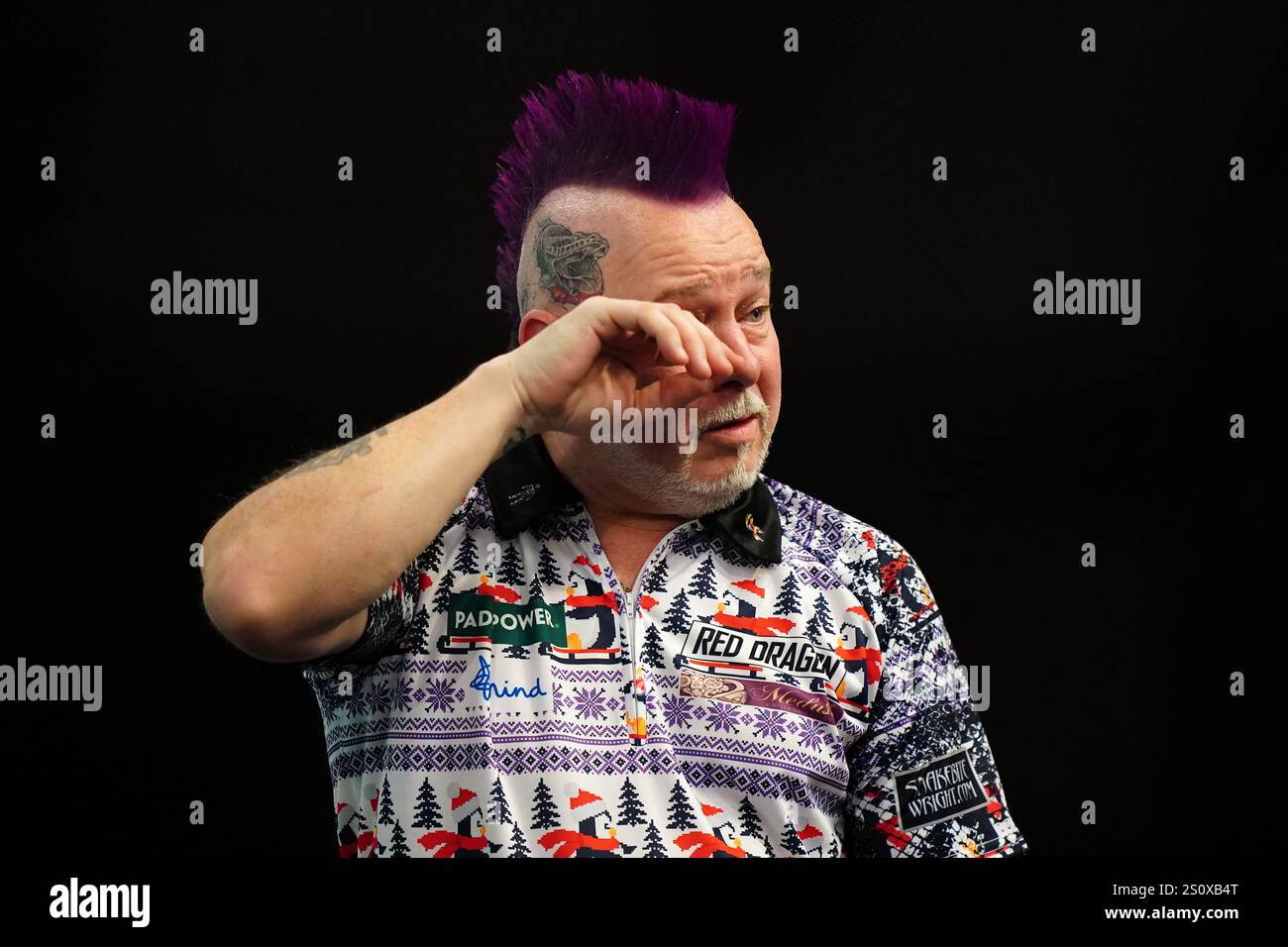Peter Wright reacts after winning his fourth round match against Luke ...