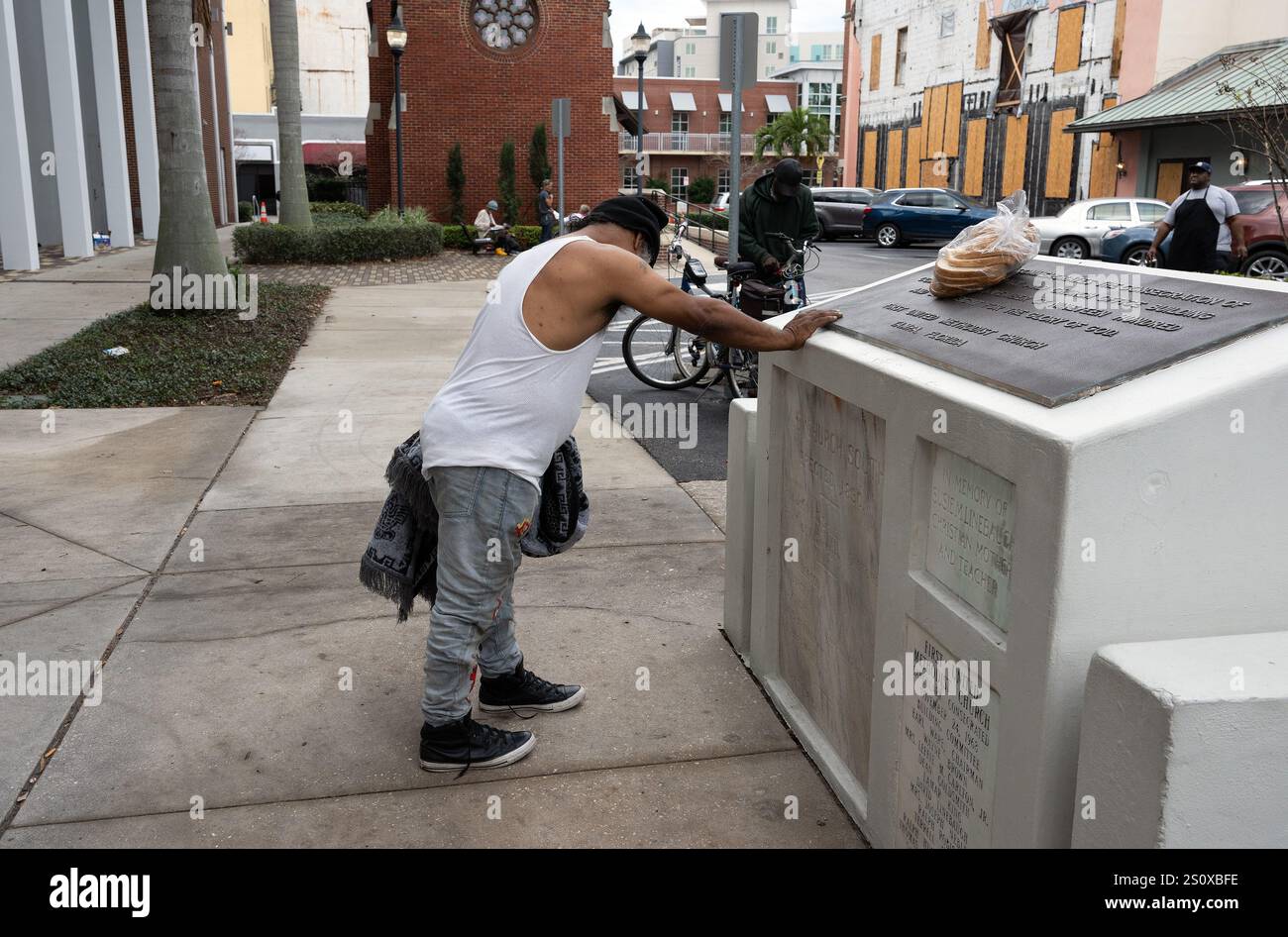 Tampa, Florida, USA. 29th Dec, 2024. A homeless man struggles to ...