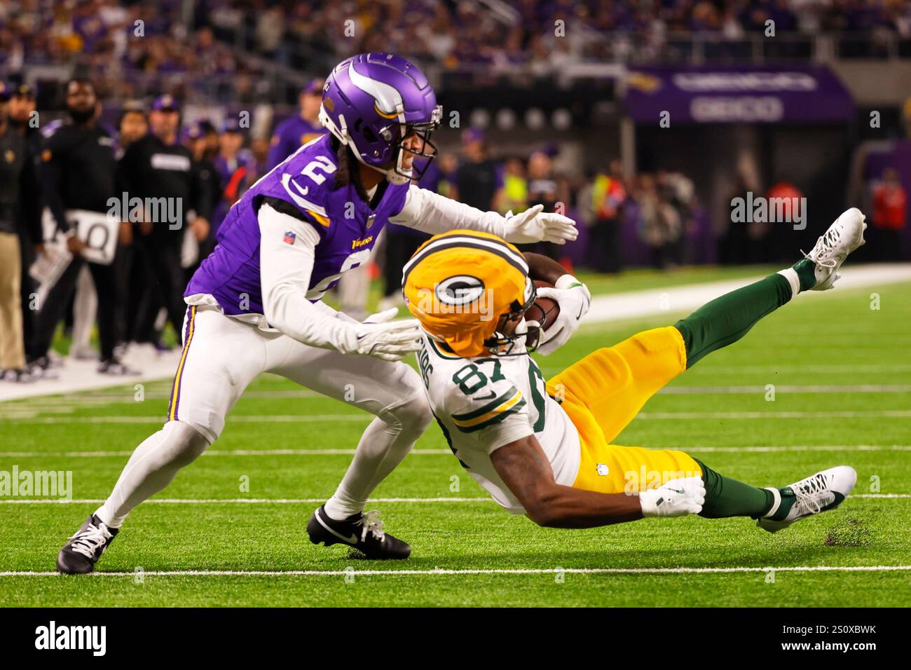 Green Bay Packers' Romeo Doubs is stopped by Minnesota Vikings' Stephon ...