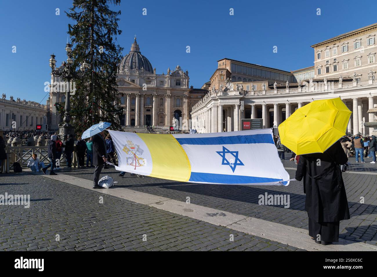 A banner in St. Peter's Square with the flags of Vatican City and ...