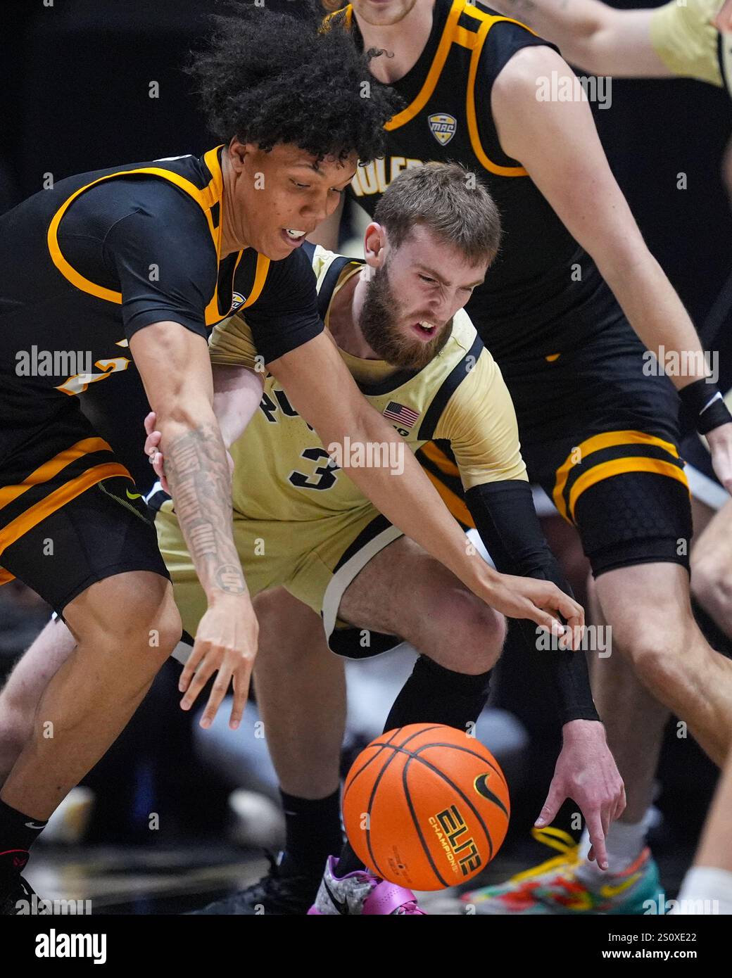 Toledo guard Bryce Ford (2) and Purdue guard Braden Smith (3) go for a ...