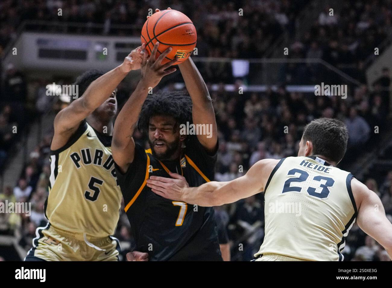 Toledo guard Isaiah Adams (7) drives between Purdue guard Myles Colvin ...